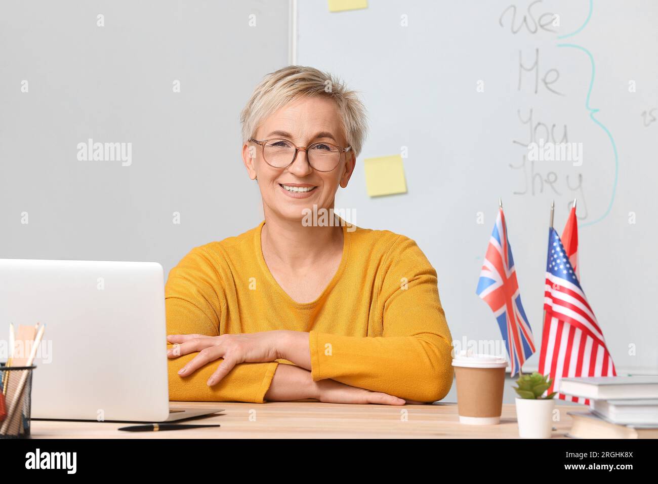 Female English teacher giving online lesson in classroom Stock Photo ...