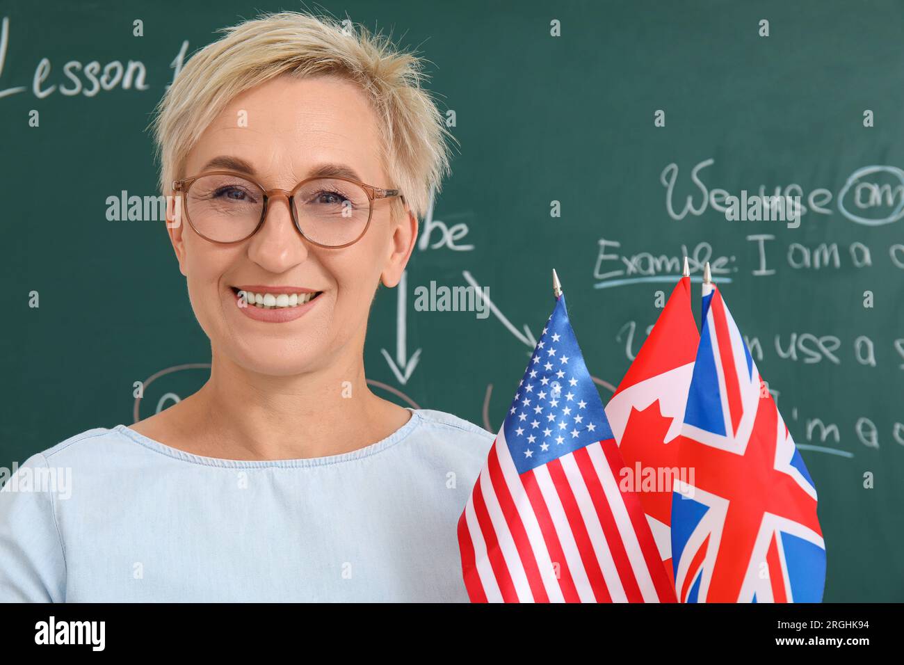 Female English teacher with different flags in classroom, closeup Stock ...