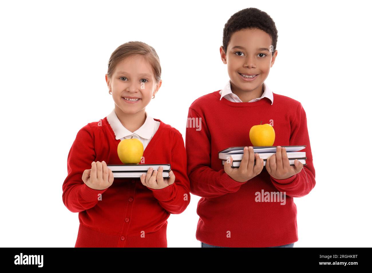 Little students with books and apples on white background Stock Photo ...