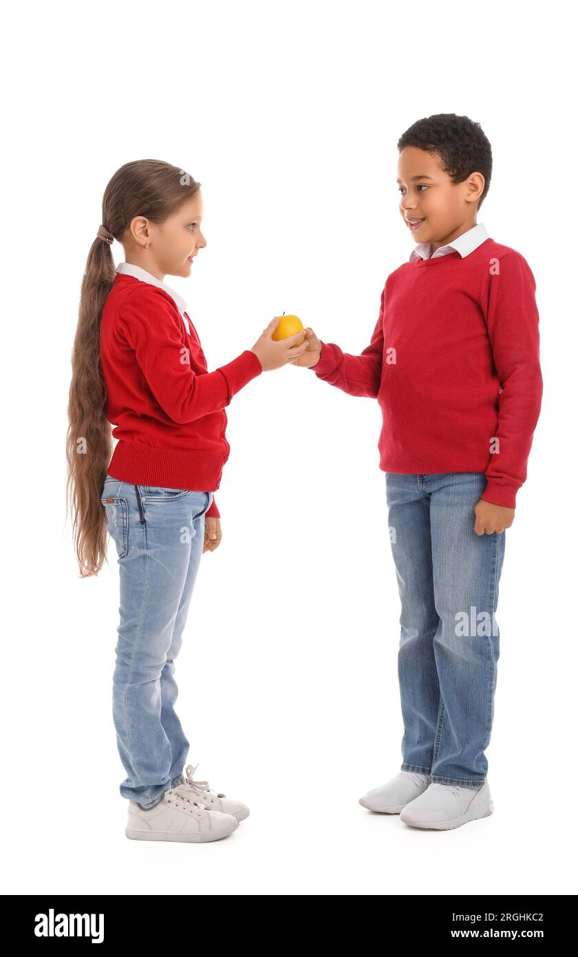 Little students with apple on white background Stock Photo - Alamy