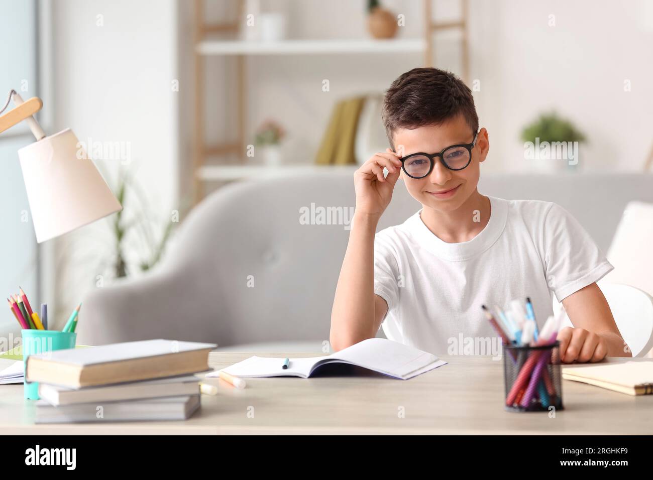 Little boy doing lessons at home Stock Photo - Alamy
