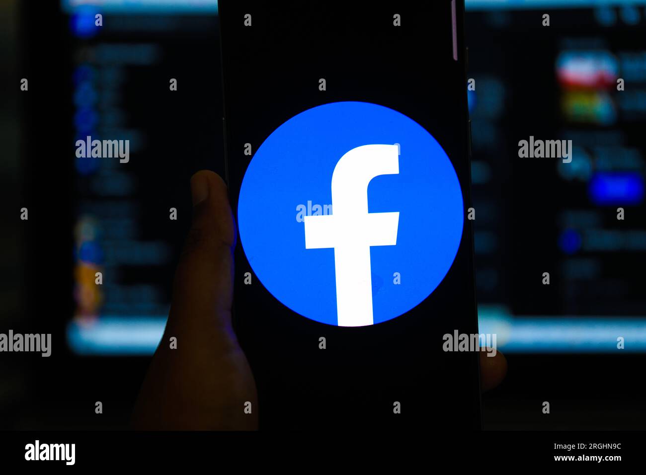 In this photo illustration, a woman uses Facebook on her smartphone ...