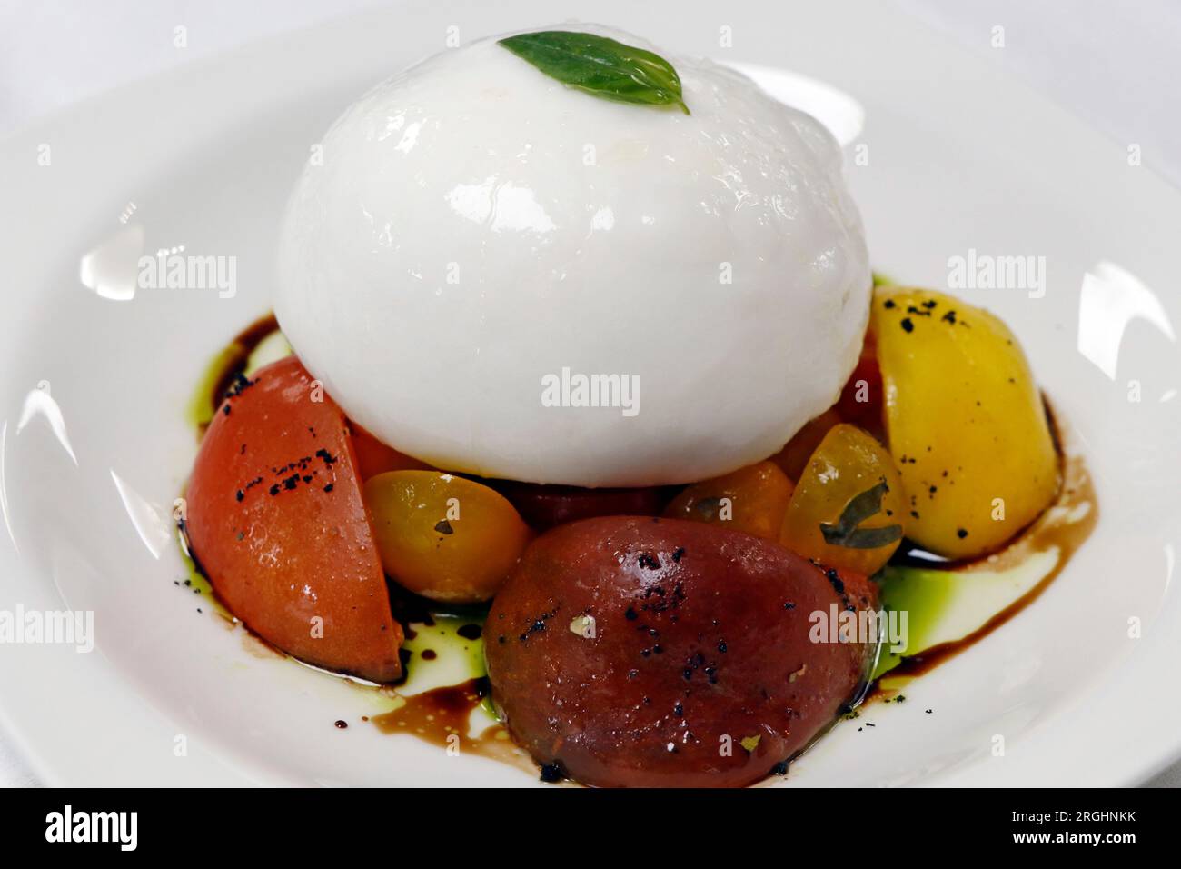 italian buffalo mozzarella with heirloom tomato salad Stock Photo - Alamy