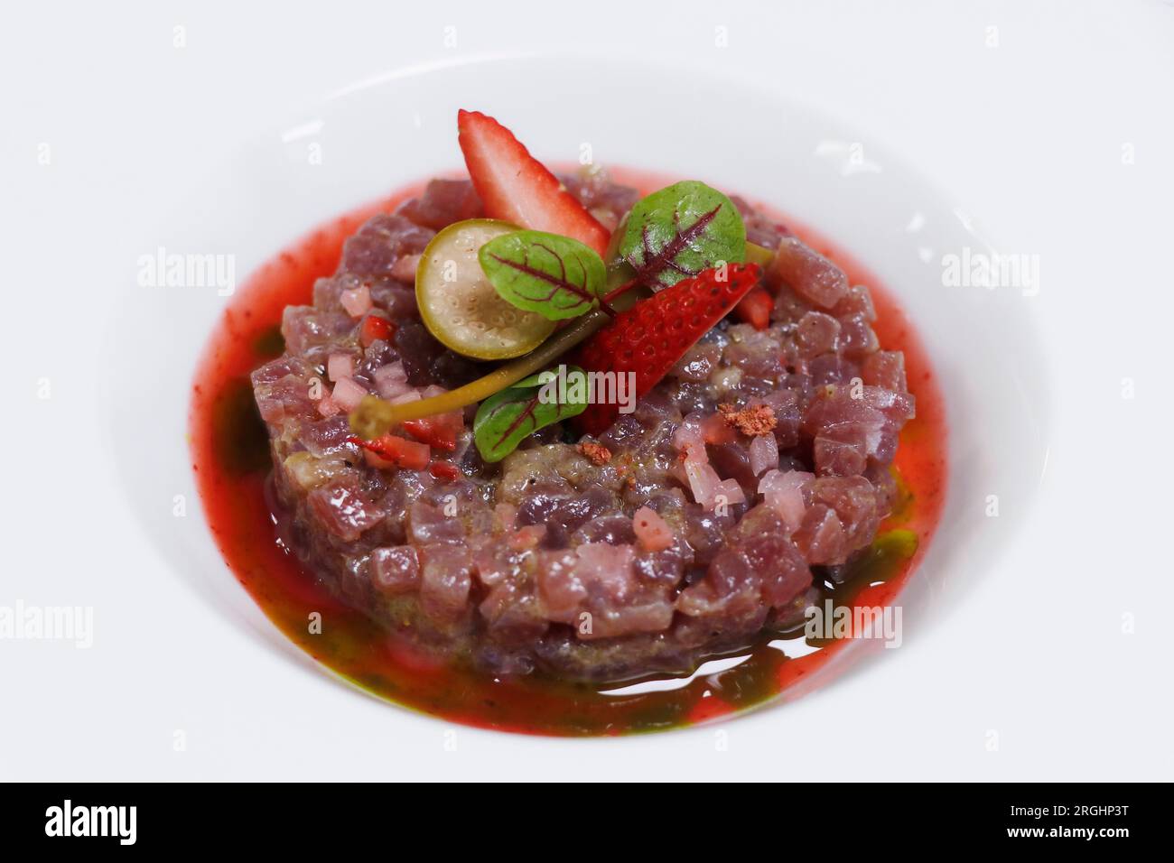 mediterranean food speciality, tuna tartare with strawberry in a white ...