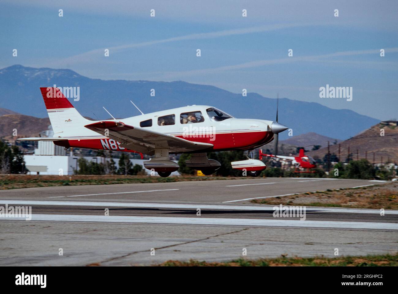 A red and white single engine private airplane takes off from Riverside ...