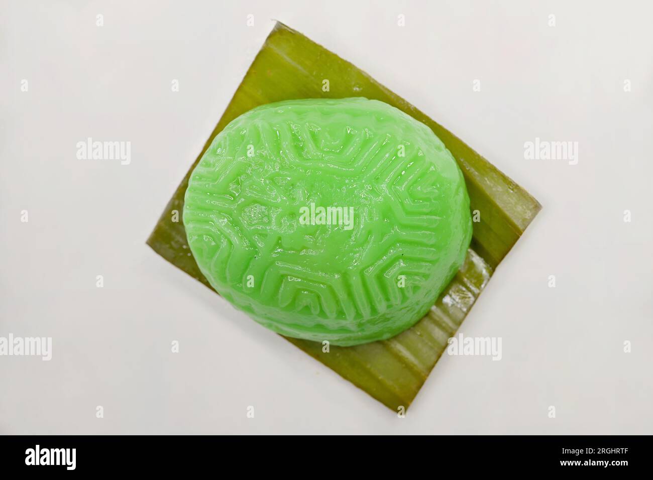 A steamed tortoise cake with green skin or Ang Ku Kueh molded to ...