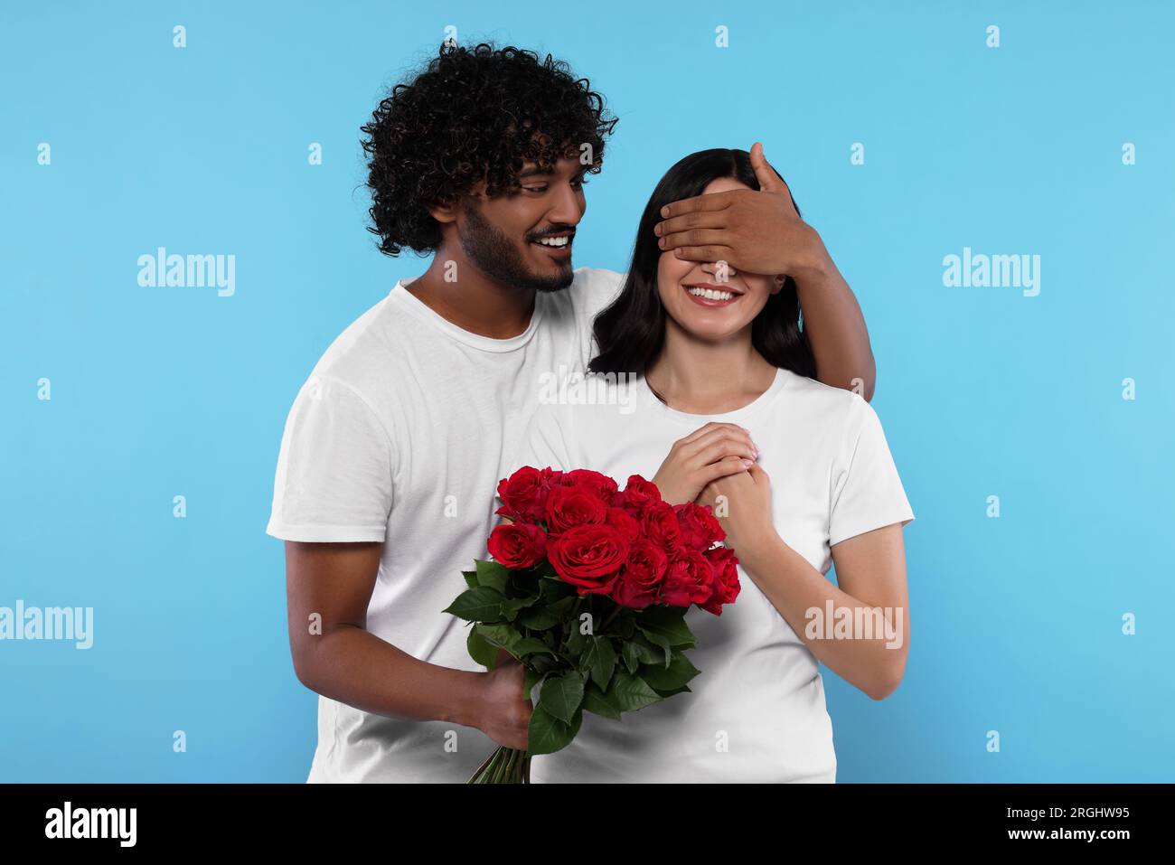 International dating. Handsome man presenting roses to his beloved ...