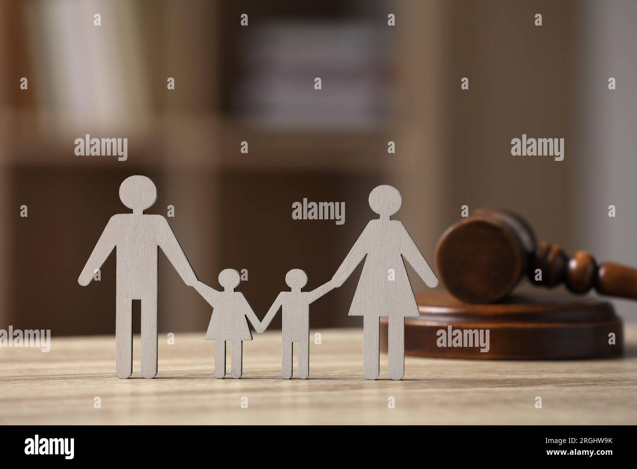 Family law. Figure of parents with children and gavel on wooden table ...