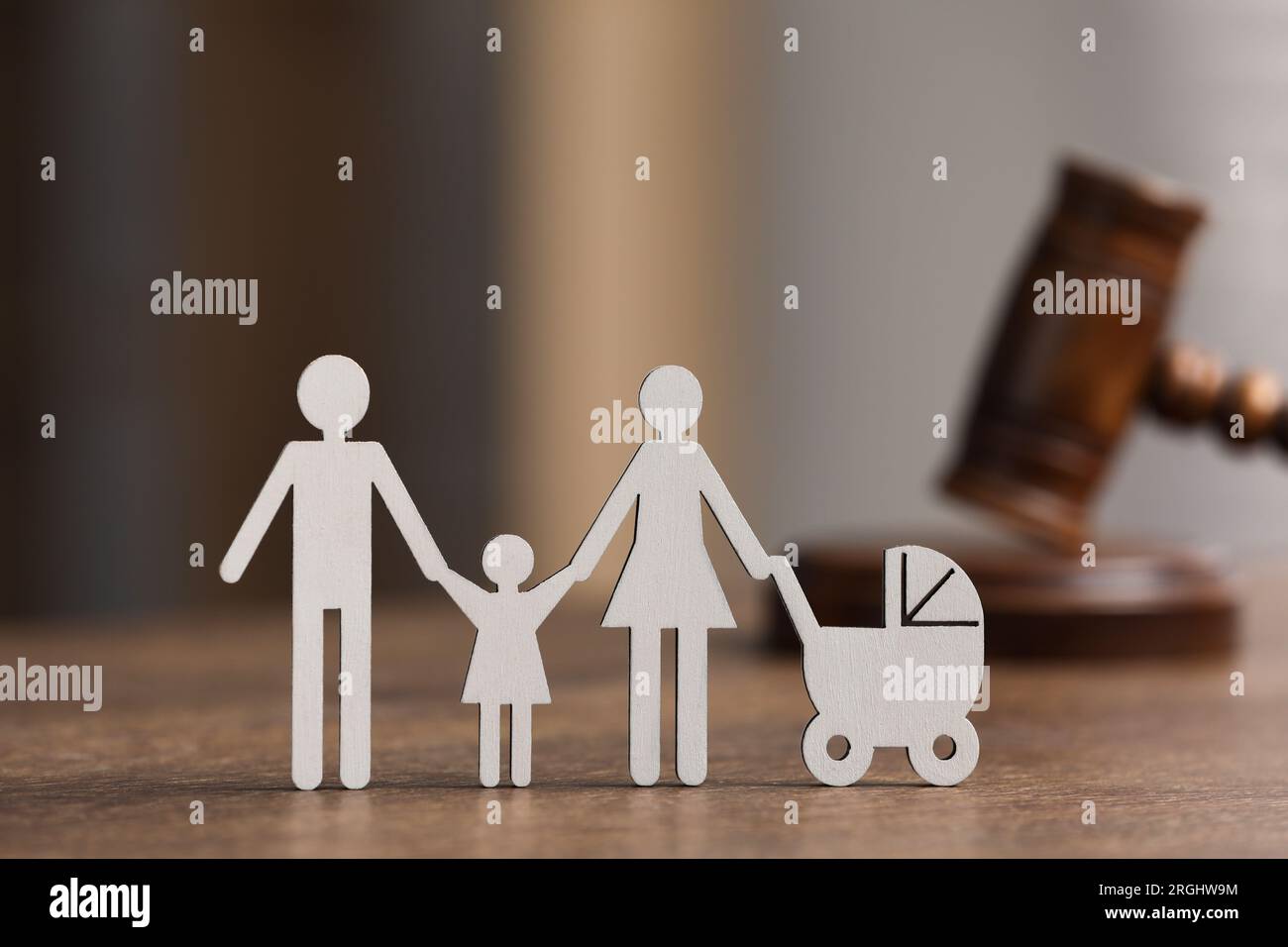 Family law. Figure of parents with children and gavel on wooden table ...