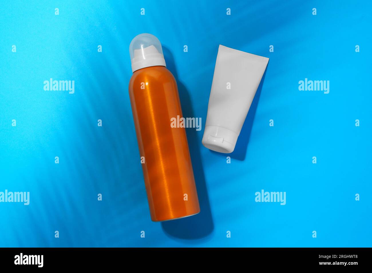 Sunscreens on light blue background, flat lay. Sun protection care ...