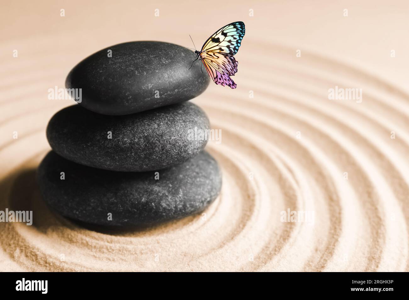 Peace and harmony. Stacked zen garden stones on sand with pattern and ...