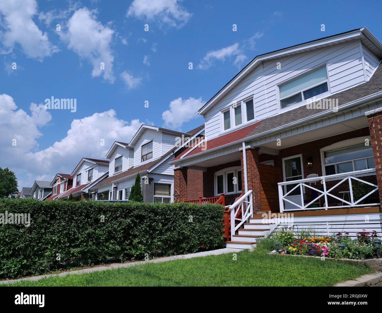 Residential street, row of similar houses with second floor dormer ...