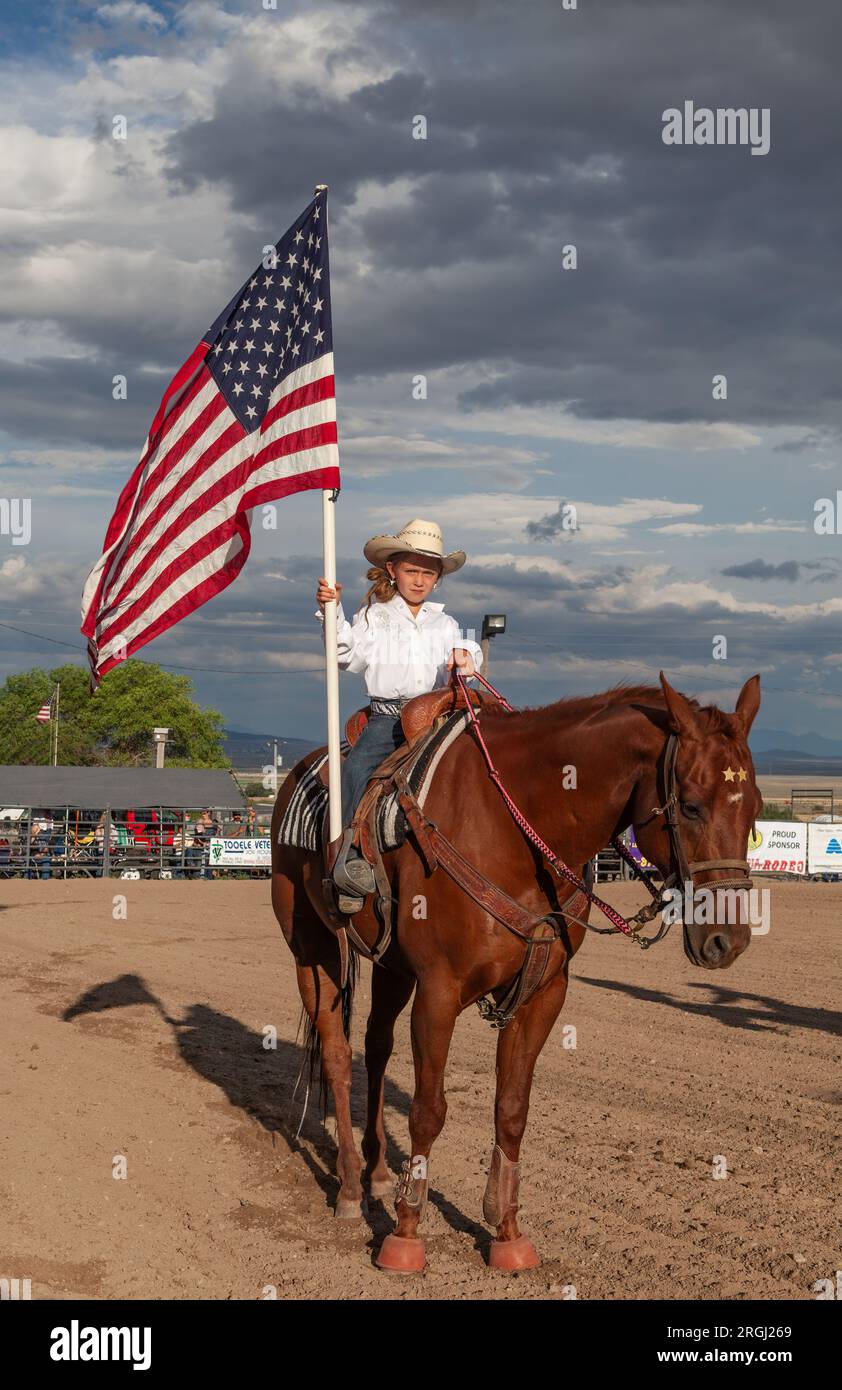 Cowgirl on horseback with American flag during opening ceremony of Rush ...