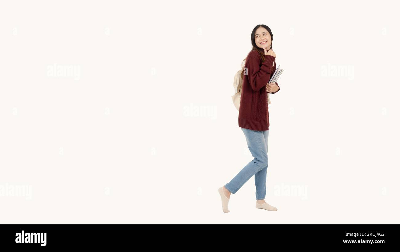 An attractive and happy young Asian female college student in a red ...