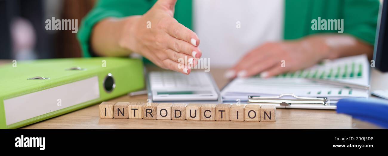 Letters introduction collected from wooden cubes and manager with hand ...