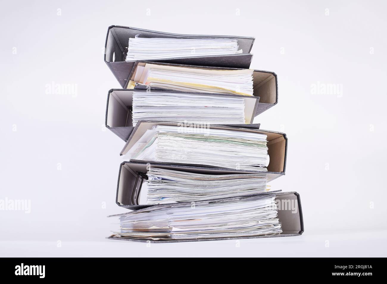 stack of black file folders full of documents against white background ...
