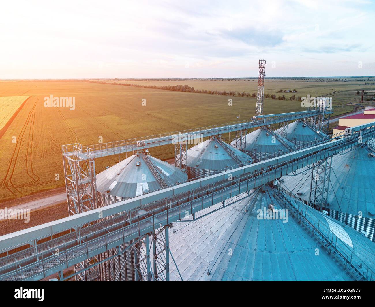 Modern metal silos on agro-processing and manufacturing plant. Aerial ...