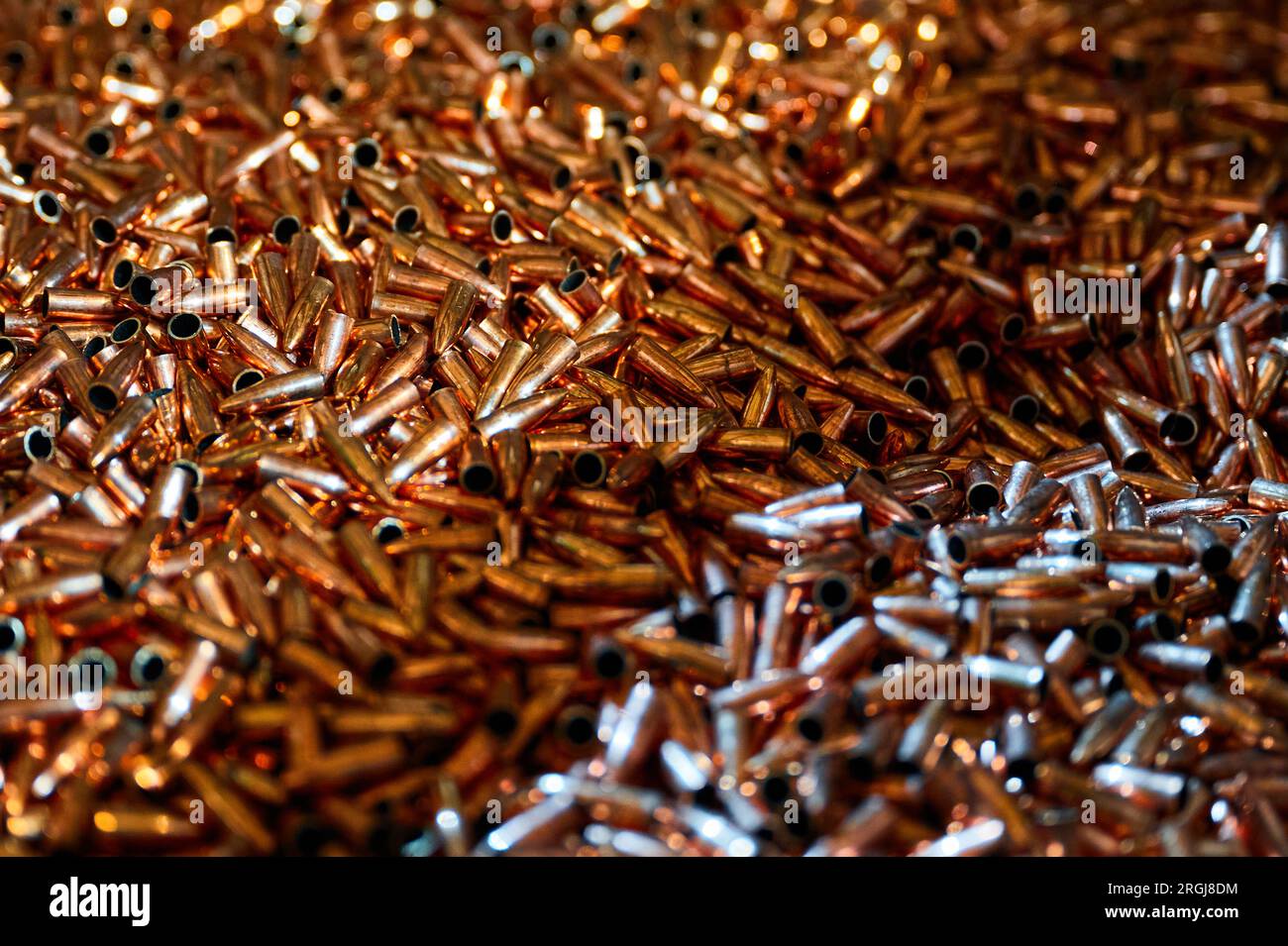 Sparkling golden bullets heap for firearms as background Stock Photo ...