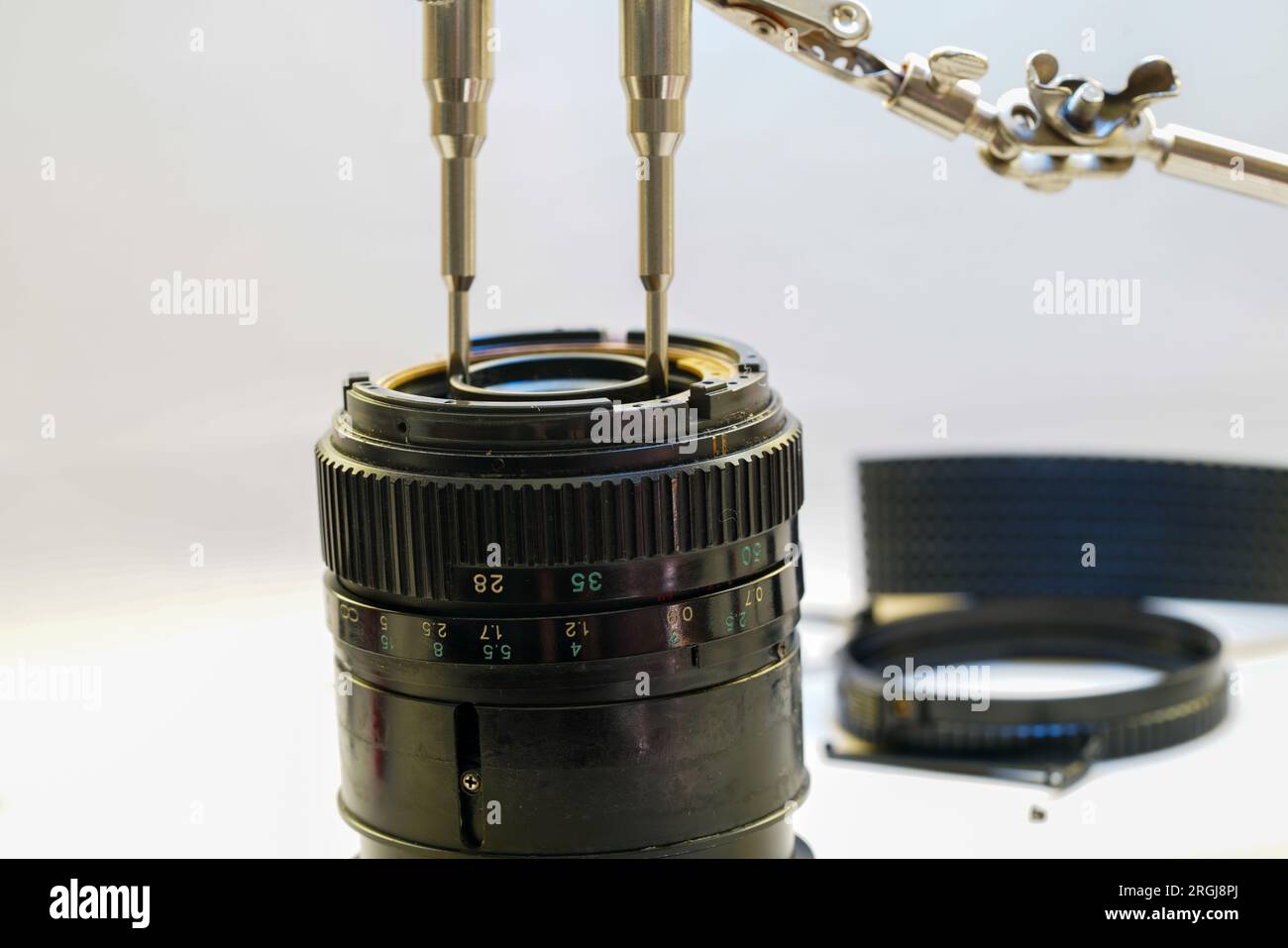 Clean and disassemble the lens for photography into its component parts ...