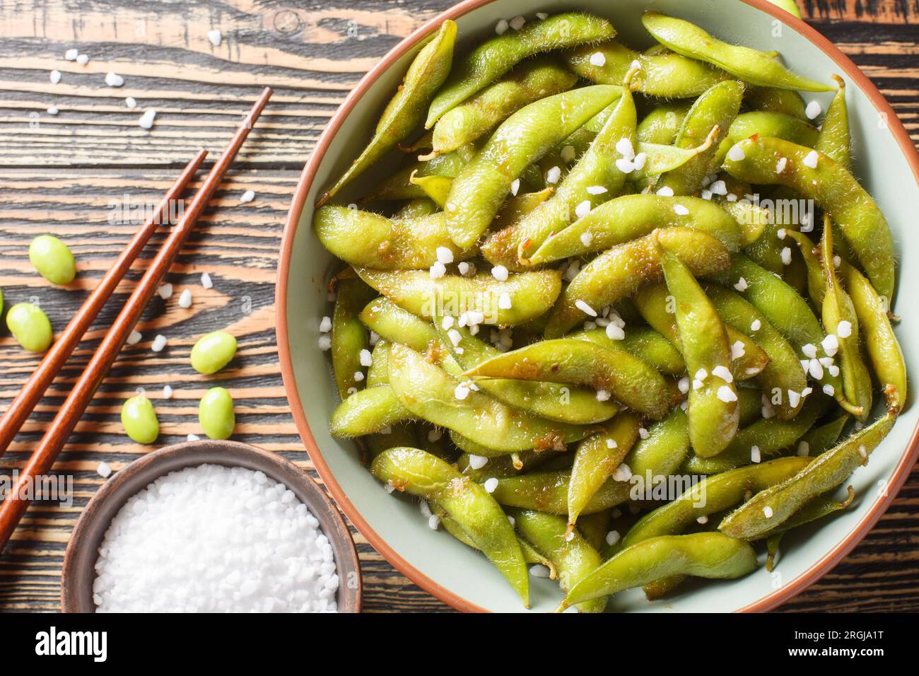 Stir-fried green soy beans edamame seasoned garlic and salt closeup on ...