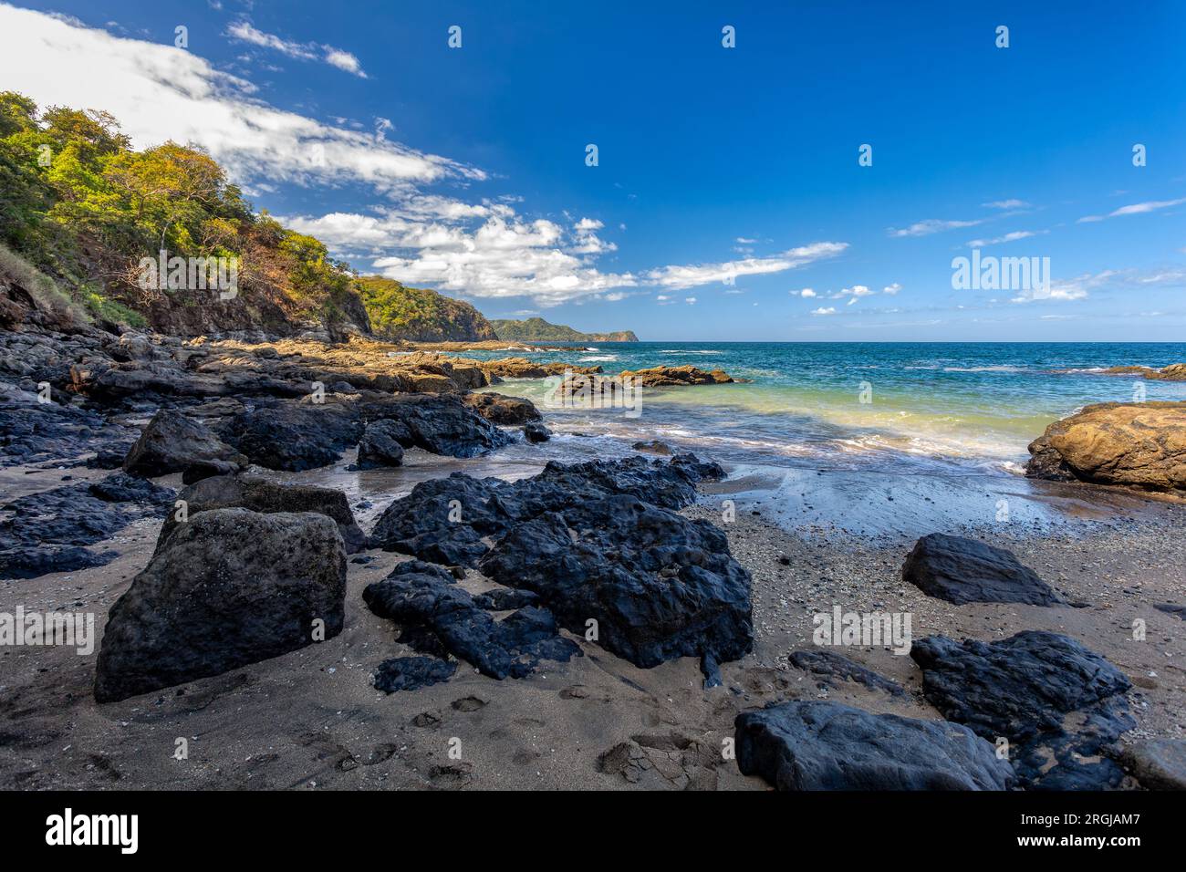 Playa Ocotal with Pacific ocean waves on rocky shore, El Coco Costa ...