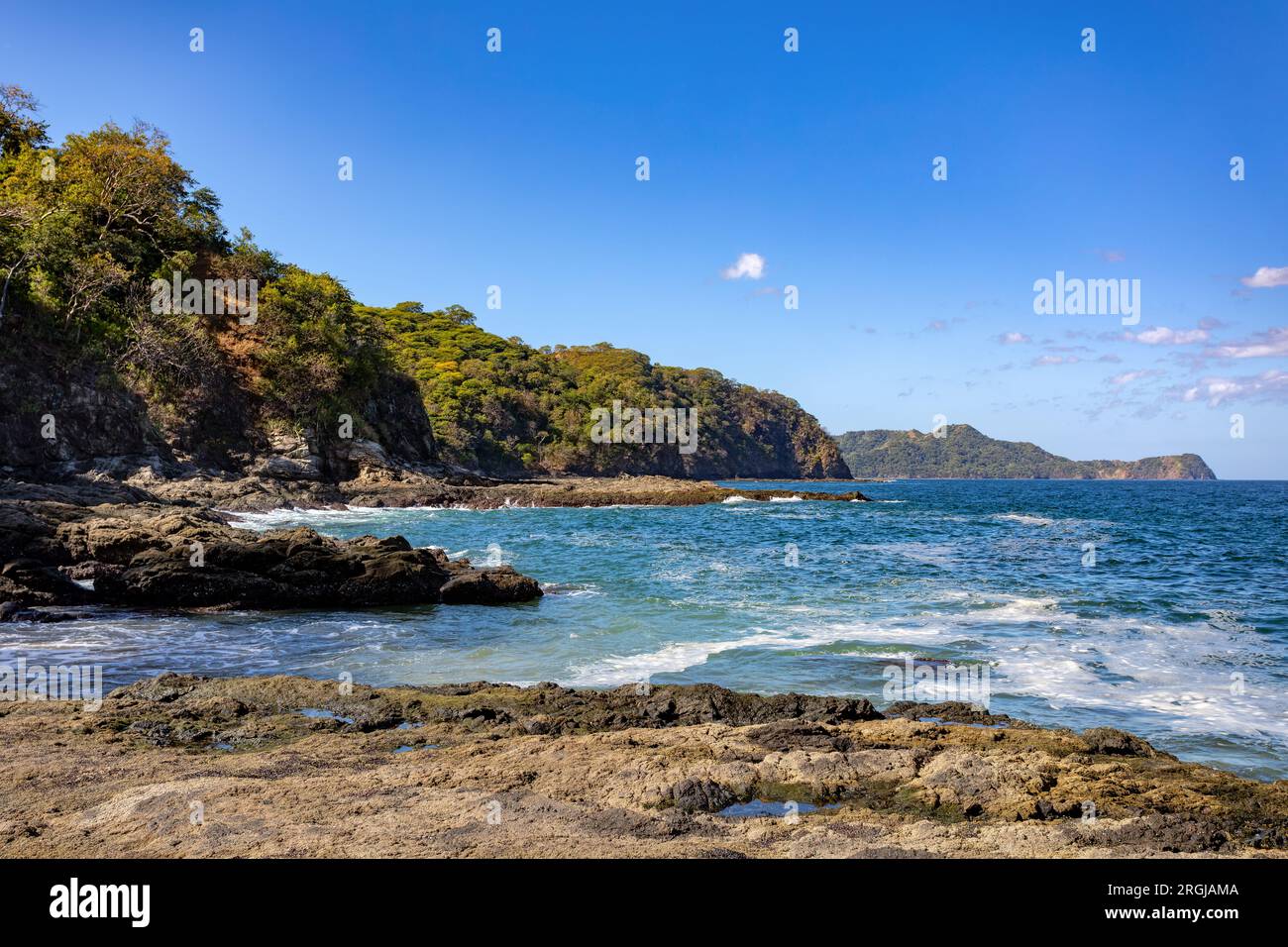 Playa Ocotal with Pacific ocean waves on rocky shore, El Coco Costa ...