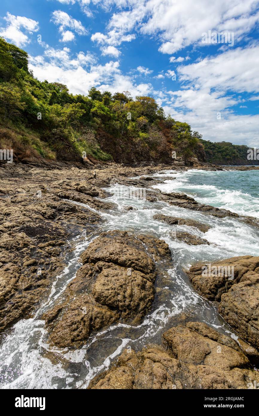 Playa Ocotal with Pacific ocean waves on rocky shore, El Coco Costa ...