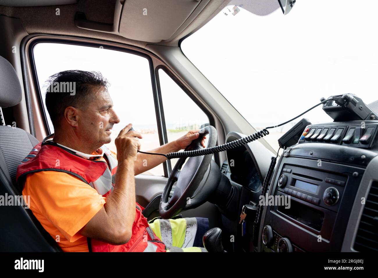 View from inside of a lifeguard using the radio of the ambulance Stock ...