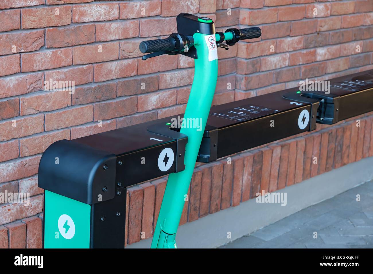 A parked electric scooter rental stand on a city street. Scooters on ...