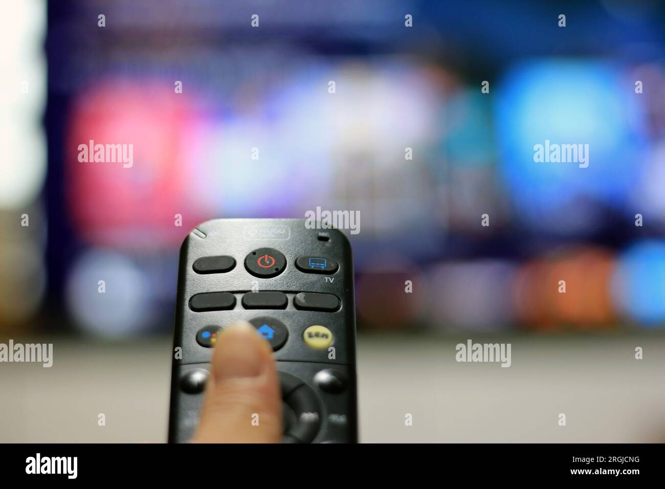 Cord Cutters Watching tv and using remote control Stock Photo - Alamy