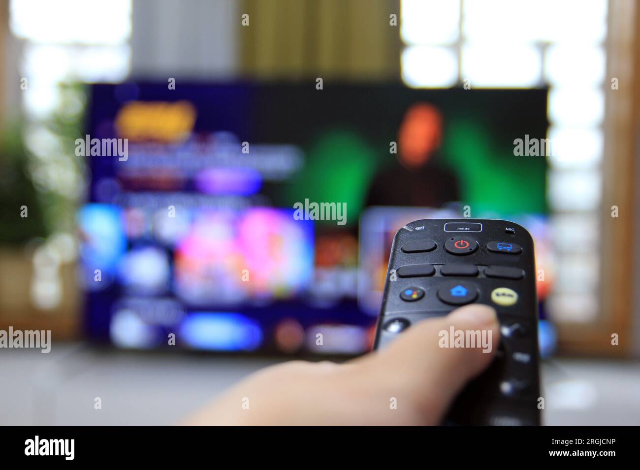 Cord Cutters Watching tv and using remote control Stock Photo - Alamy