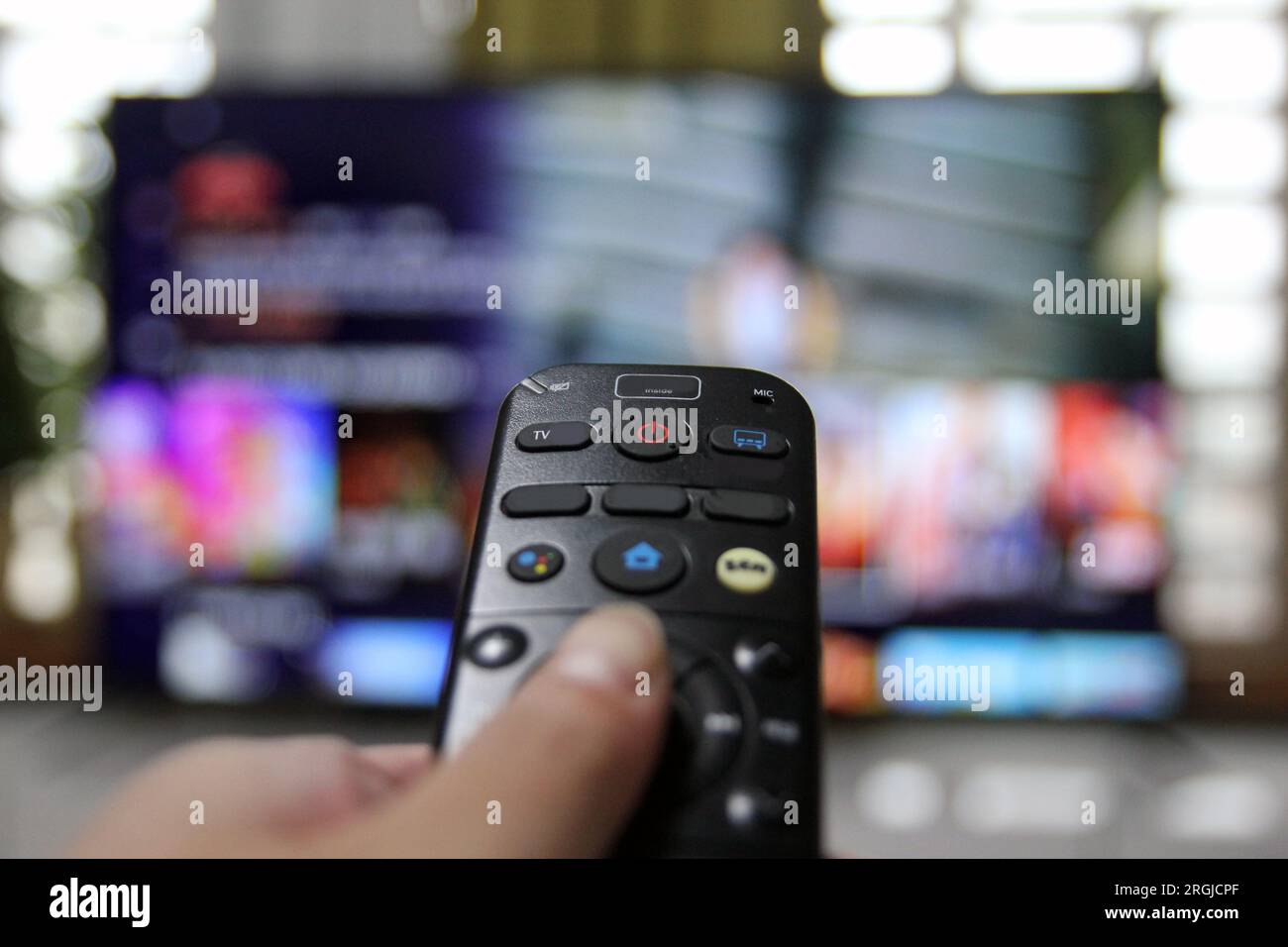 Cord Cutters Watching tv and using remote control Stock Photo - Alamy