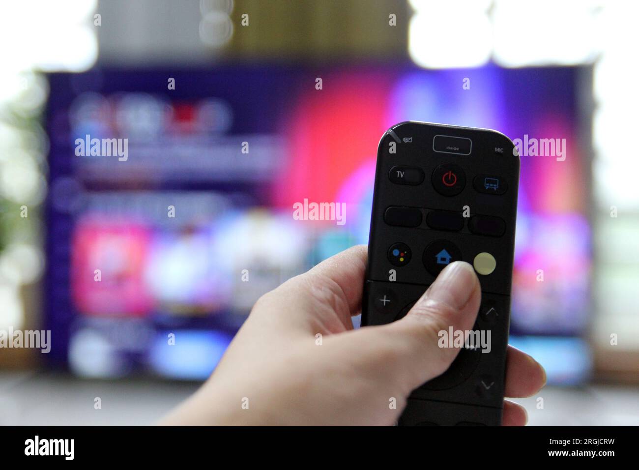 Cord Cutters Watching tv and using remote control Stock Photo - Alamy