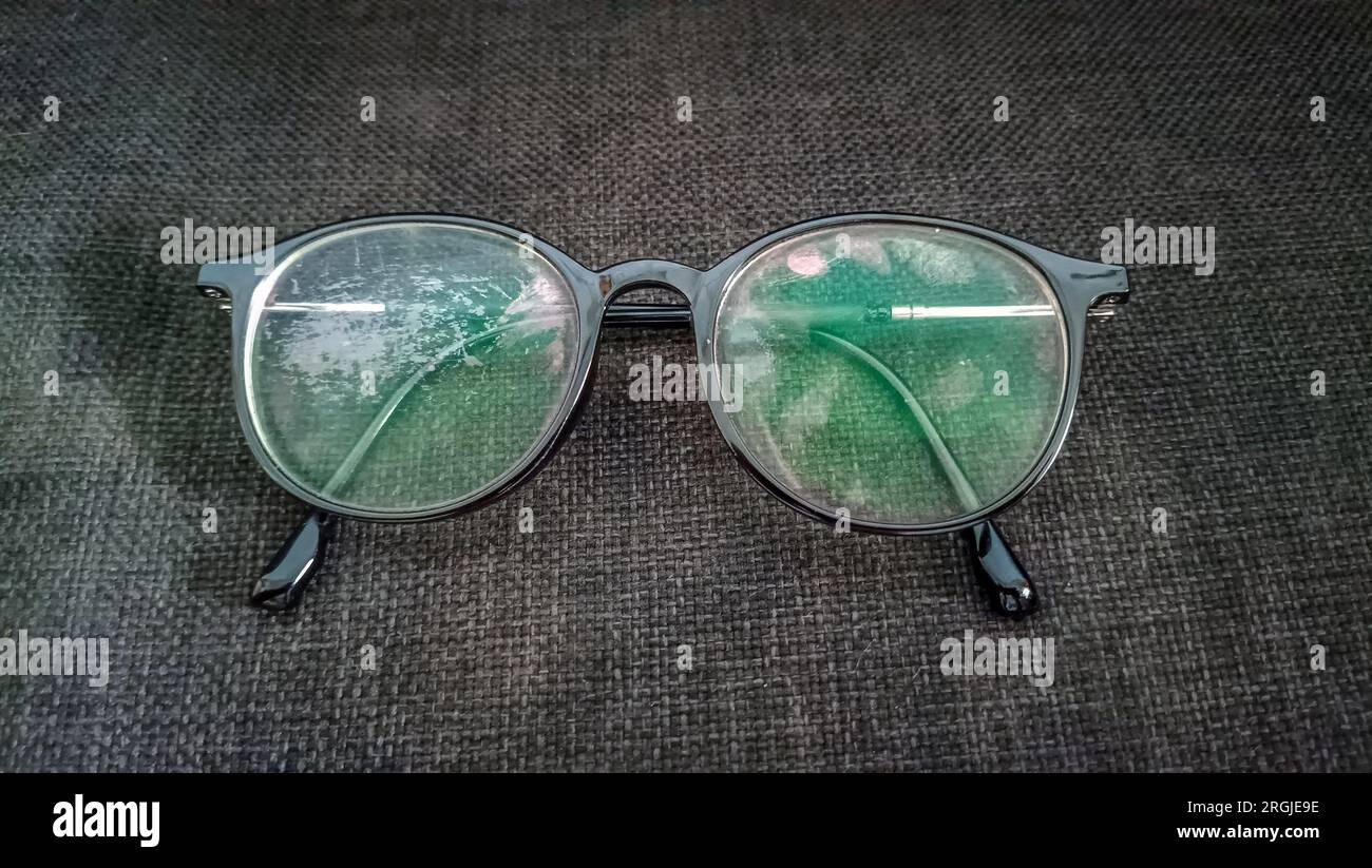 Glasses with black frames with scratched and stained lenses Stock Photo ...