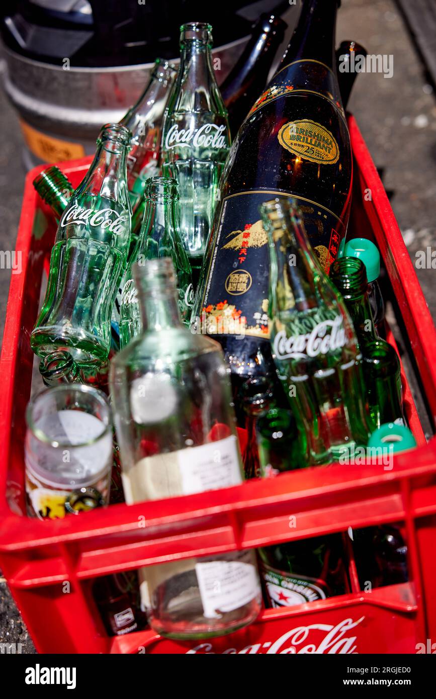 Empty Coca-Cola bottles and other bottles in a red Coca-Cola plastic ... Empty Coca-Cola bottles and other bottles in a red Coca-Cola plastic ...