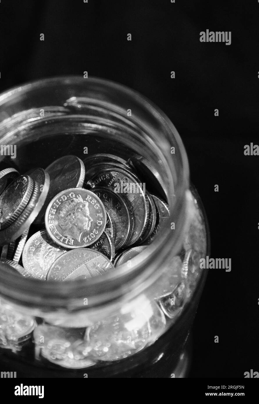 A collection of British coins in a glass jar Stock Photo - Alamy