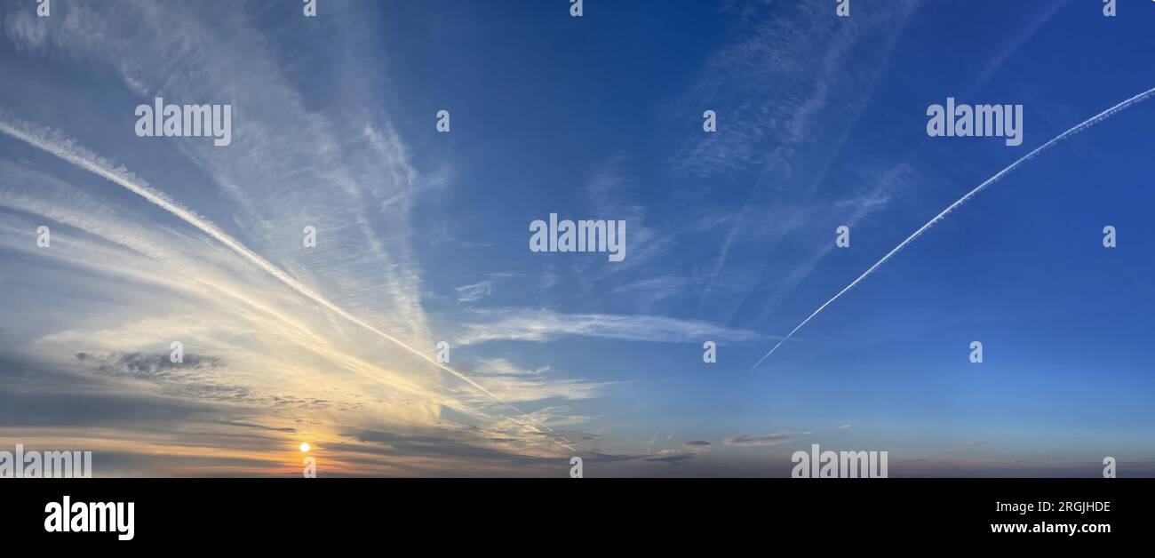 Dramatic dinamic evening blue sky with sun and white cloud Stock Photo ...