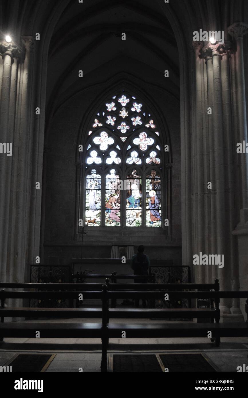 A single figure among the church pews is silhouetted against the ...