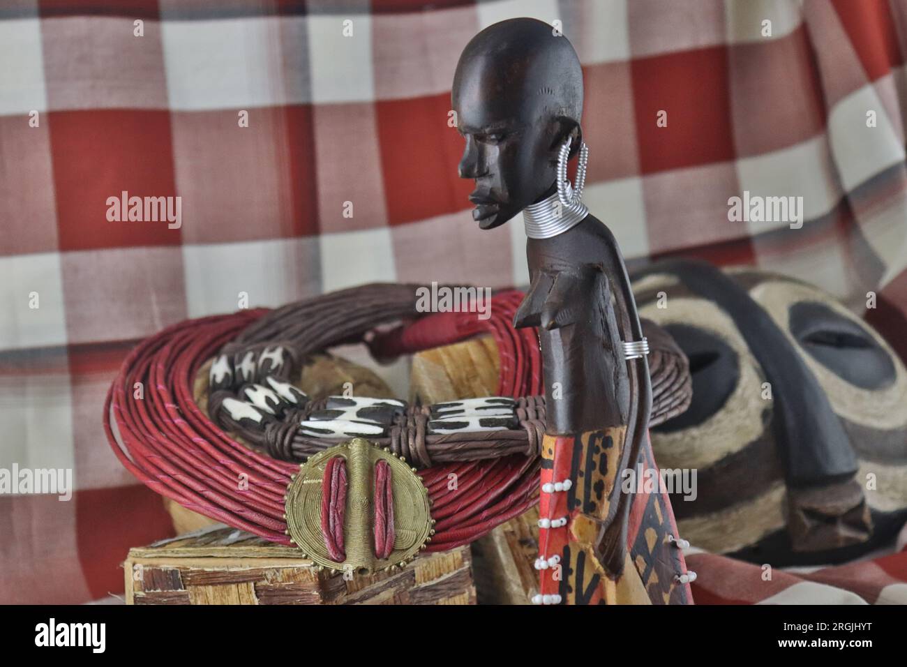 African tribal necklace and souvenirs, figurines in with background ...