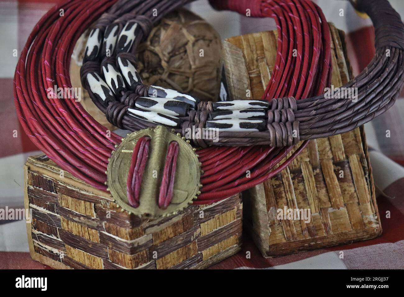 African tribal necklace and souvenirs, figurines in with background ...