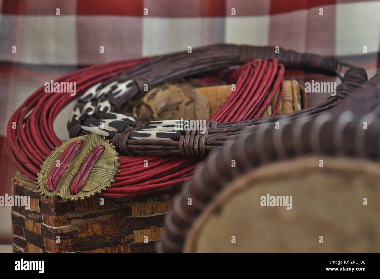 African tribal necklace and souvenirs, figurines in with background ...