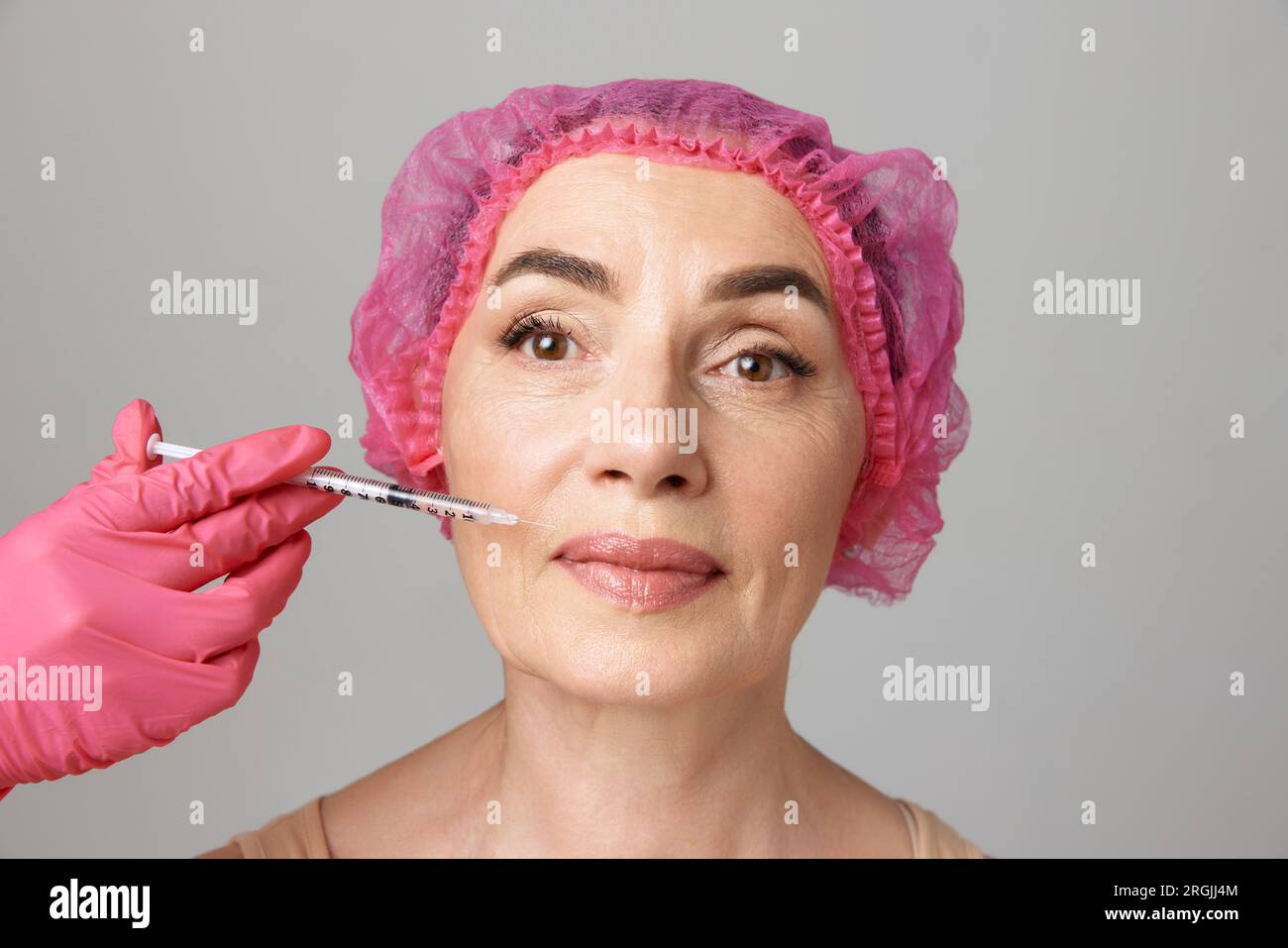 Smoothing out wrinkles.Portrait of elder woman doing beauty injection ...