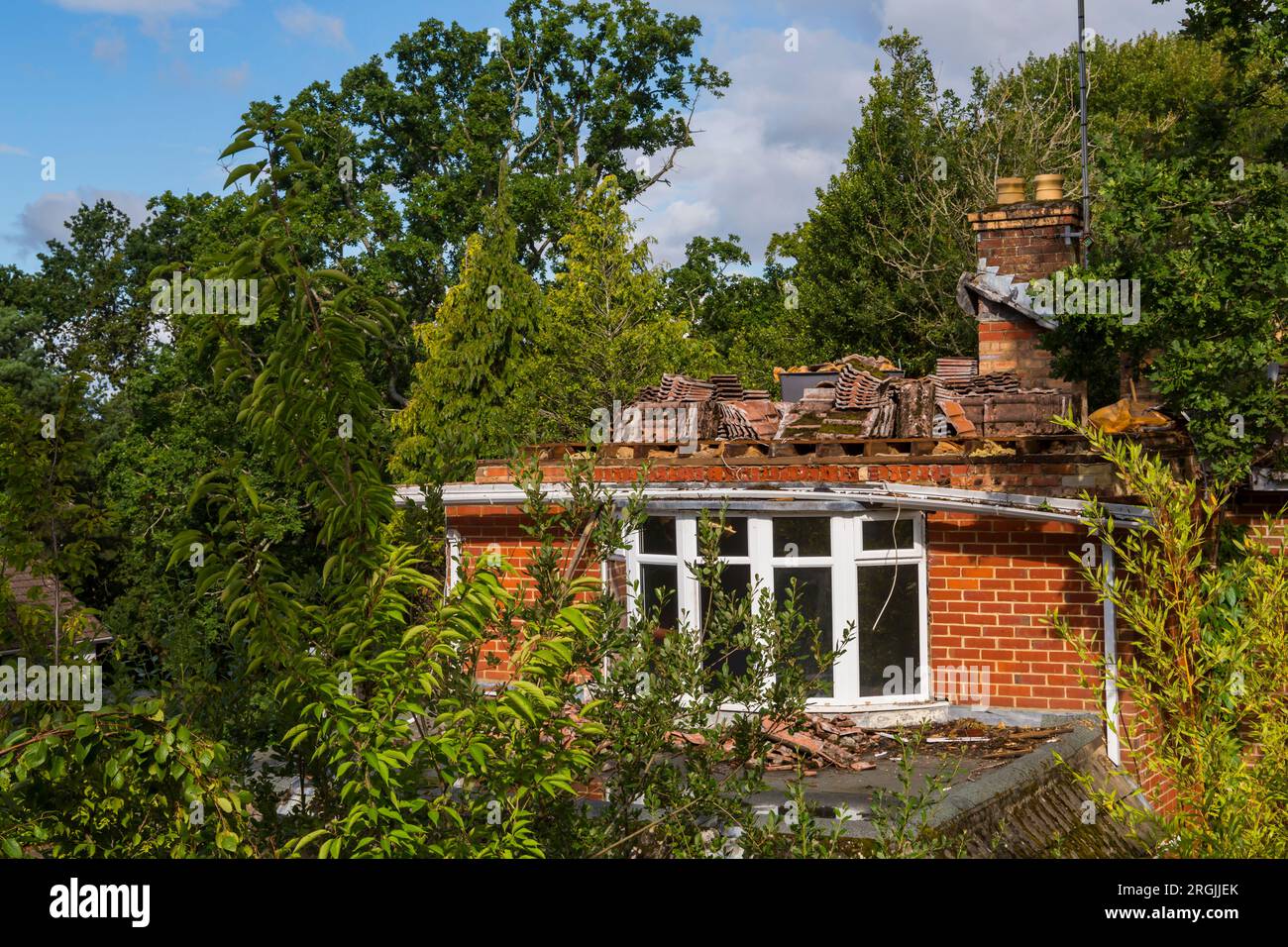 Start of house demolition removing tiles from roof at house in ...