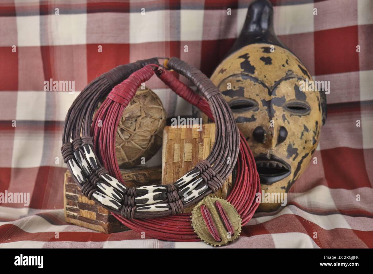 African tribal necklace and souvenirs, figurines in with background ...