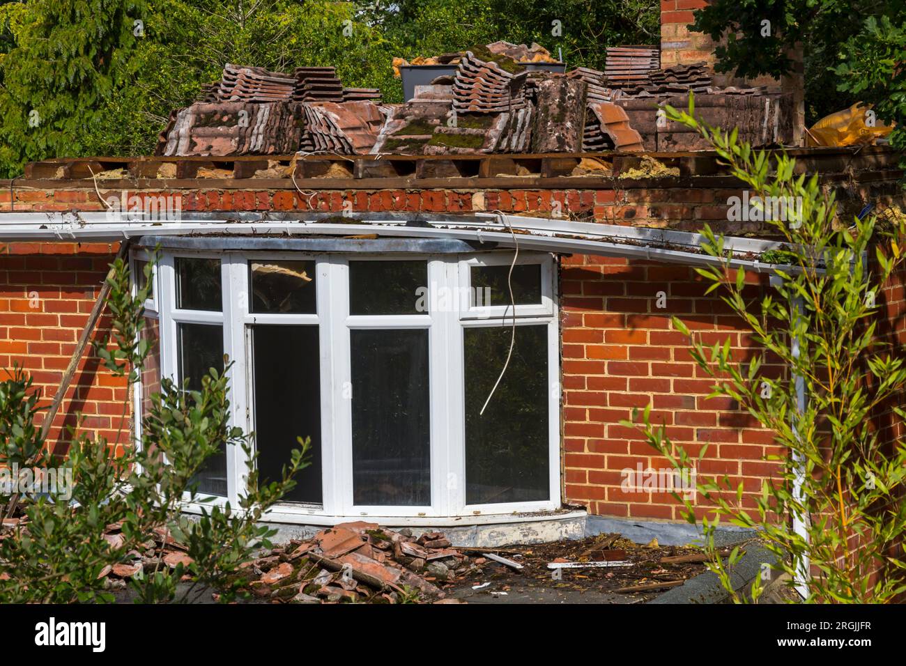 Start of house demolition removing tiles from roof at house in ...