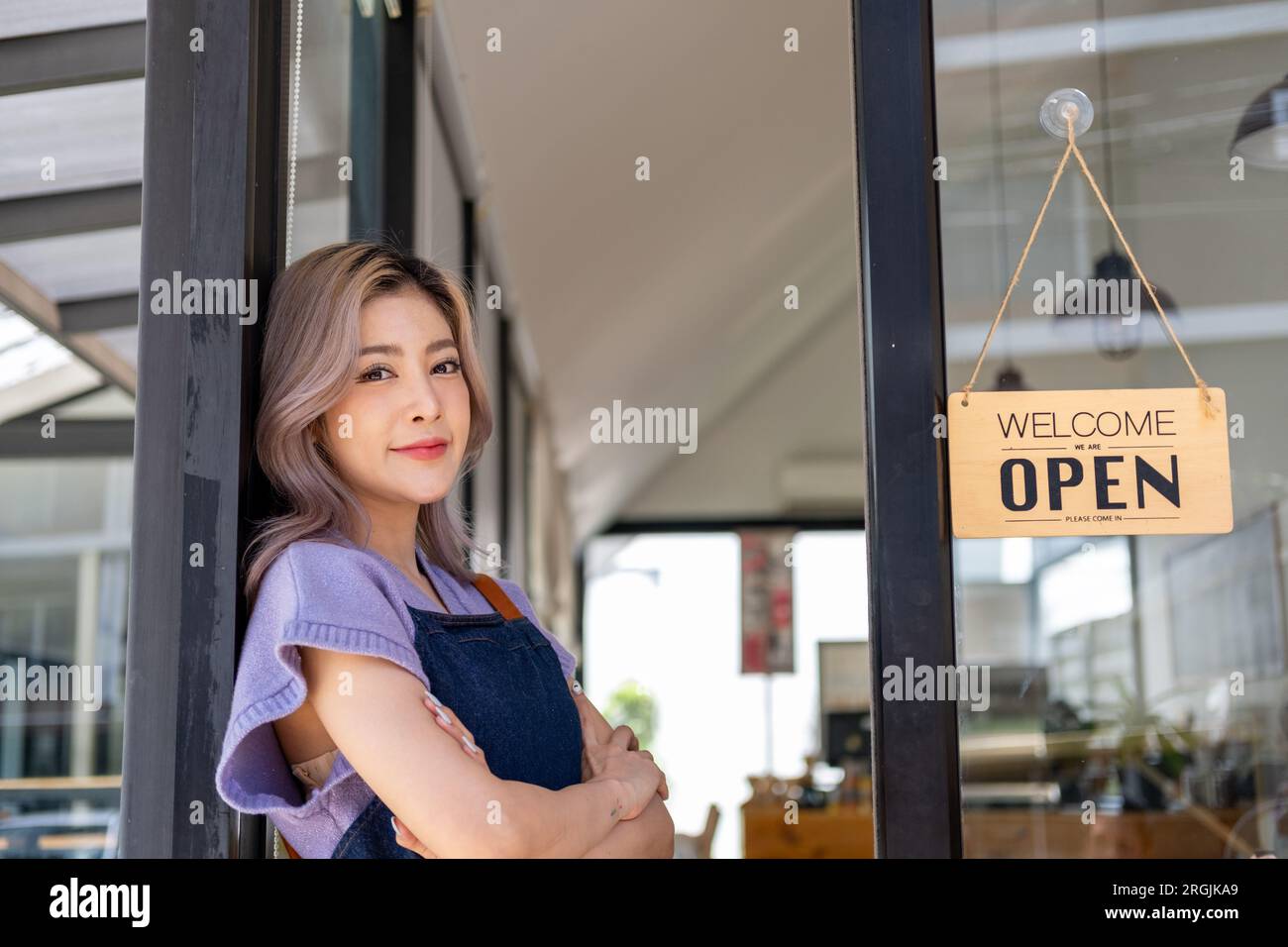Happy young business owner waitress standing at restaurant coffee shop ...