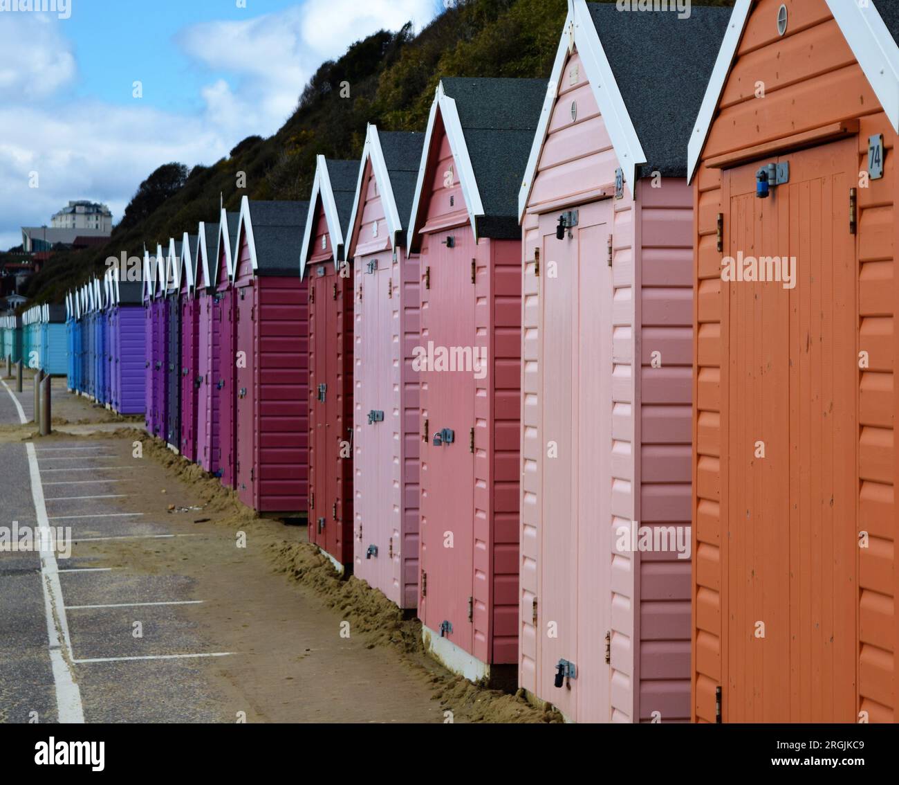Colourful beach huts in Bournemouth lined up by hue Stock Photo - Alamy