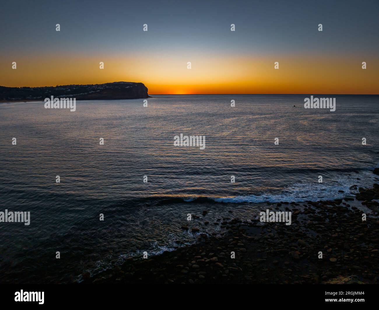 Cloudless aerial sunrise calm seas at Macmasters Beach on the Central ...