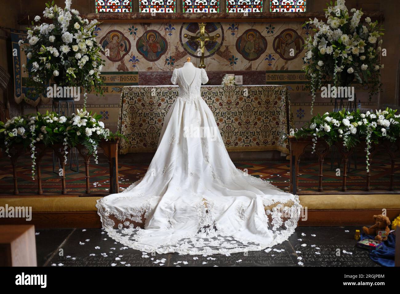 White wedding dress on display before the altar of a church Stock Photo ...