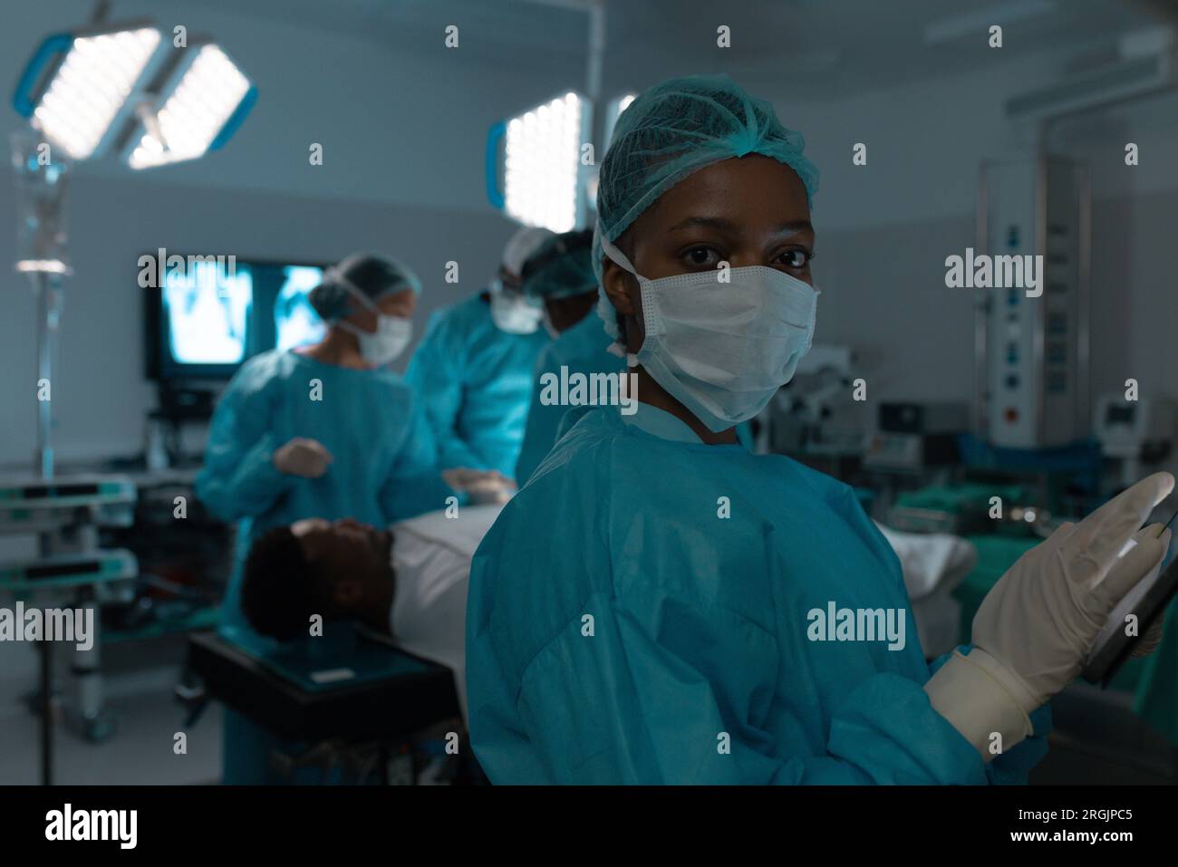 Portrait of african american female surgeon wearing surgical gown in ...